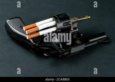 Revolver Loaded With Cigarettes - Smoking Kills Stock Photo - Alamy