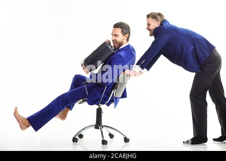 Isolated business man pushing chair Stock Photo - Alamy