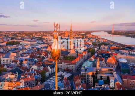 Golden rooster on a spire overlooking the old town of Riga in Latvia ...