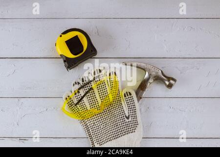 Protective gloves on wooden board construction concept Stock Photo - Alamy