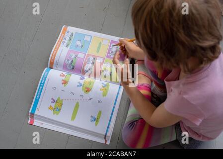A child works on school work at home Stock Photo - Alamy