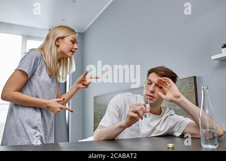 portrait of young caucasian woman chastising husband for his antics ...