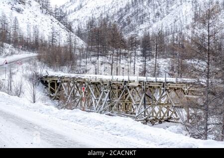 Wooden bridge, snowy mountains, gulag, Kolyma, the R504 Kolyma Highway ...
