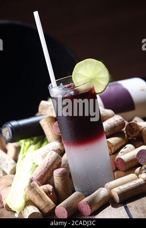 A vertical shot of an alcoholic cocktail surrounded by smoke on a ...