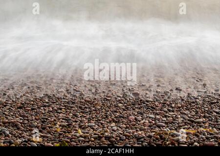 Beach pebbles in the surf, Mainland, Newfoundland and Labrador NL ...