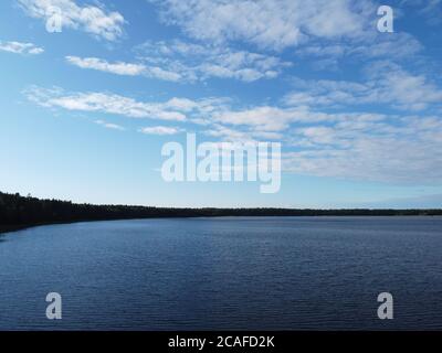 An aerial view of a large body of water surrounded by rolling hills ...