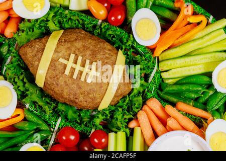 Football meatloaf with colorful vegetable, egg and sauce for Super Bowl ...