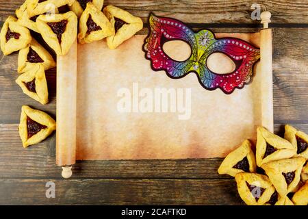 Purim celebration concept (jewish carnival holiday) over white wooden ...
