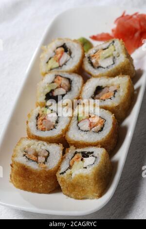 Closeup shot of sushi rolls with fried greens on a black surface Stock ...