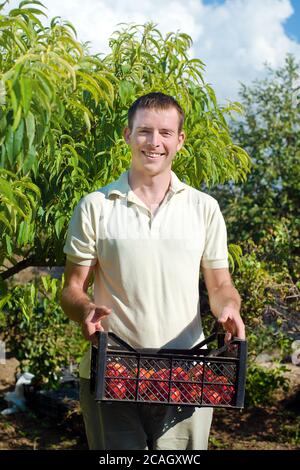 Young man farmer holding fresh eggs in hands on farm Stock Photo - Alamy