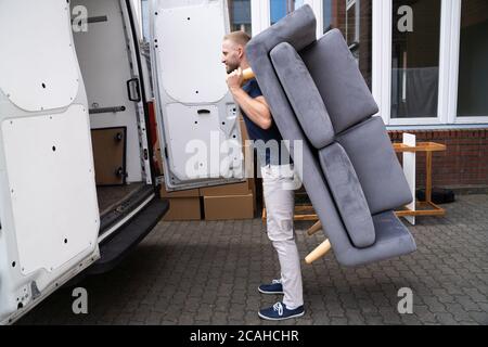 Delivery man move furniture carry sofa for moving to an apartment ...