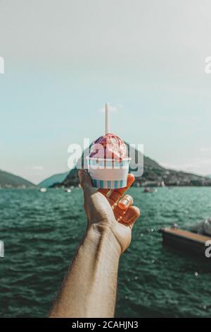 A Shallow focus vertical shot of person's hands spreading chocolate on ...