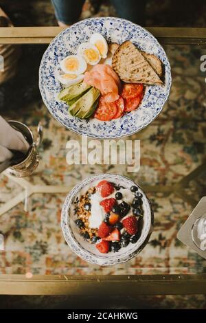 Girl at brunch in the city drinking iced coffee and eating a delicious ...