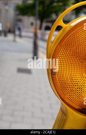 Street barricade with warning signal lamp on a fence. Construction ...