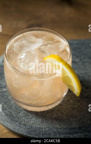 Boozy Sour Gin Fitzgerald Cocktail with a Lemon Garnish Stock Photo - Alamy
