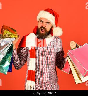 Santa with colorful packets. Guy or hipster shopper Stock Photo - Alamy