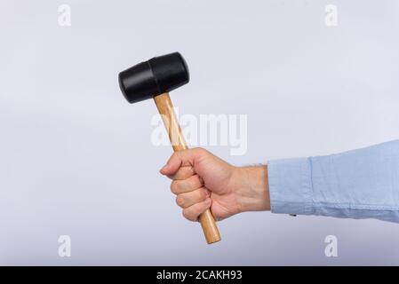 Side view of a male hand holding a freshly dug potato plant with ...