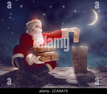 Santa Claus sitting on chimney Stock Photo - Alamy