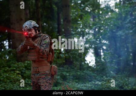 Soldier in Action at Night in the Forest Area. Night Time Military ...