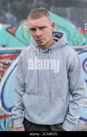 A bully guy in a light sports jacket with a hood Stock Photo - Alamy