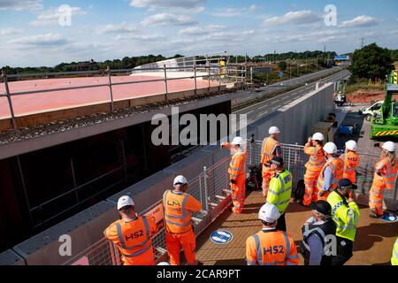 HS2 workers watch as a bridge is wheeled into position over the M42 at ...