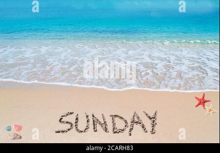 sunday written on a tropical beach under clouds Stock Photo - Alamy