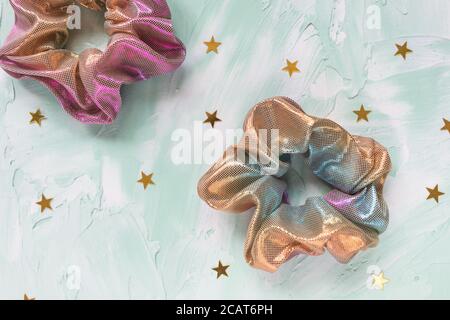 Trendy holographic scrunchie and stars on green Stock Photo - Alamy