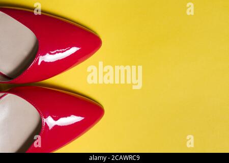 Overhead shot of vivid red woman shoes on a yellow background Stock ...