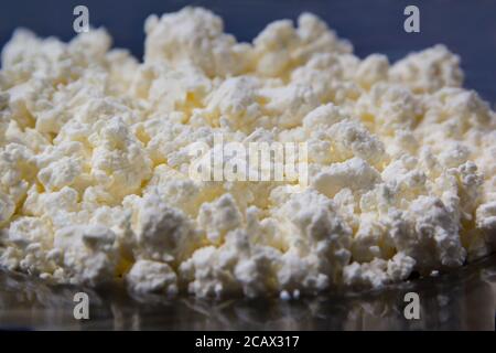 Lumps of fresh delicious cottage cheese for breakfast Stock Photo - Alamy