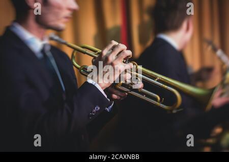 Concert view of a male trumpeter, professional trumpet player with ...