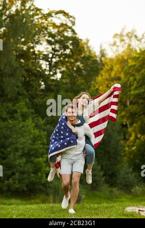 Young man with USA flag on red background Stock Photo - Alamy
