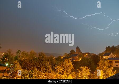 Castle photographed during a thunderstorm with lightning at night in ...