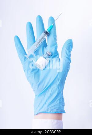 Doctor's hands holding syringe with a vaccine, medical remedy or ...