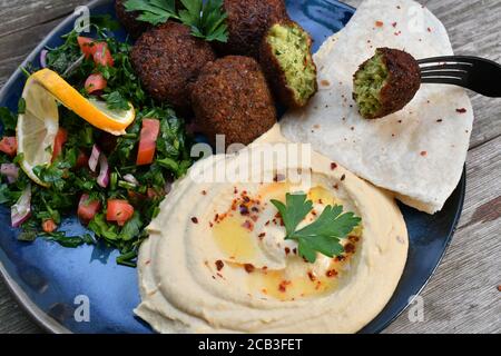 Closeup shot of traditional homemade falafel with different vegetables ...