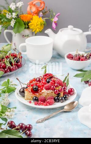 Blue plate with delicious sponge cake roll, fork and floral decor on ...