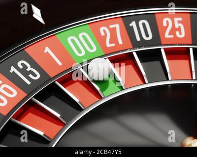 A white ball stopped at the number zero on a gold and black roulette ...