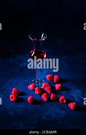 Raspberries on dark blue background Stock Photo - Alamy