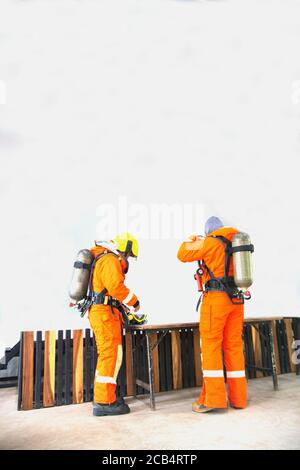 A portrait of Asian male firefighter in red protective uniform, mask ...