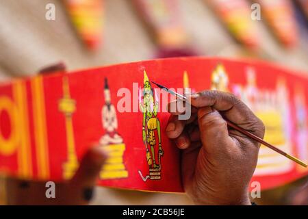 The Ceremonial bow, Onavillu. Artisan painting god's pictures on bow ...