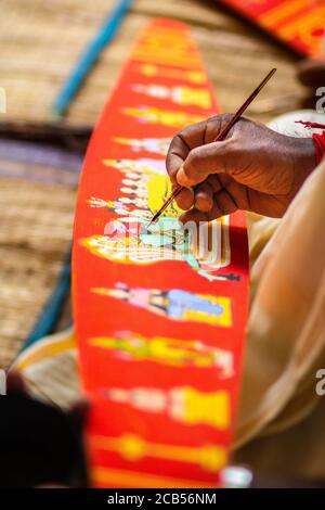 The Ceremonial bow, Onavillu. Artisan painting god's pictures on bow ...