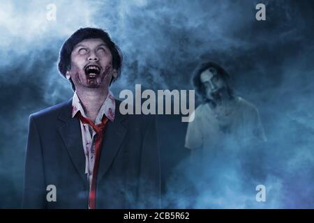 Two scary zombies with blood and wound on his body haunted the old ...