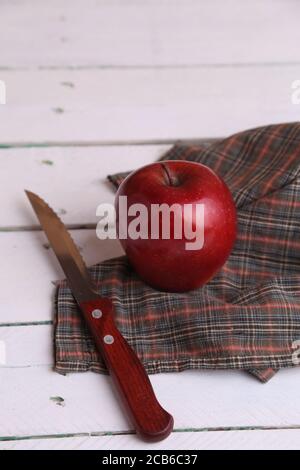 An apple on a tablecloth in a kitchen Stock Photo - Alamy