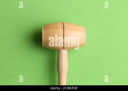 Overhead shot of a small wooden mallet on a green background Stock ...