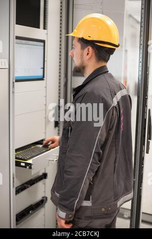 Engineer commissioning bay control unit. Engineering department. Medium ...
