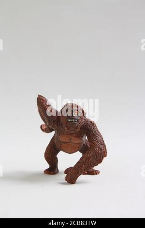 Rubber ape toy isolated on black background Stock Photo - Alamy