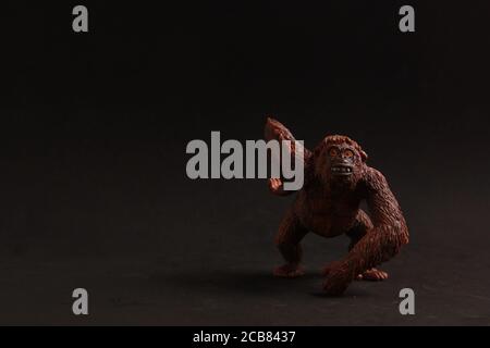 Small rubber ape toy isolated on a green background Stock Photo - Alamy