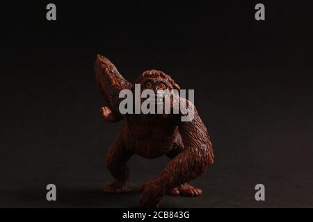 Rubber ape toy isolated on pink background Stock Photo - Alamy