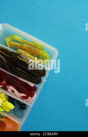 many colorful lures for fishing on the wooden pier. Selective focus ...