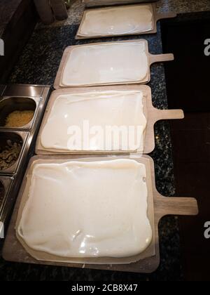 Flammekueche or tarte flambee with fromage blanc cheese, cured ham and ...