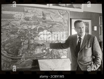 Film pioneer Walt Disney points his finger upwards as he describes his ...